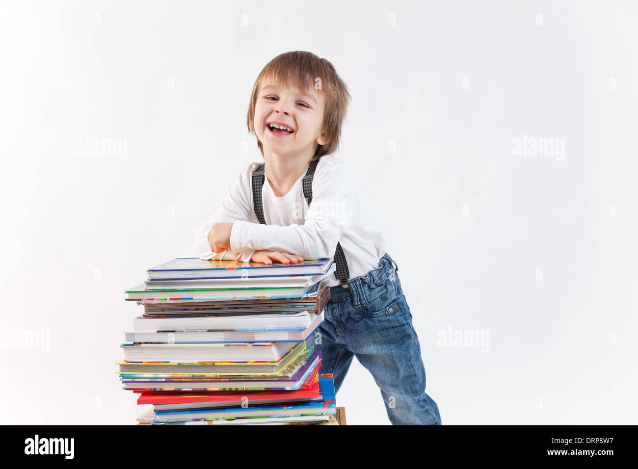 Boy with a pile of books Stock Photo - Alamy