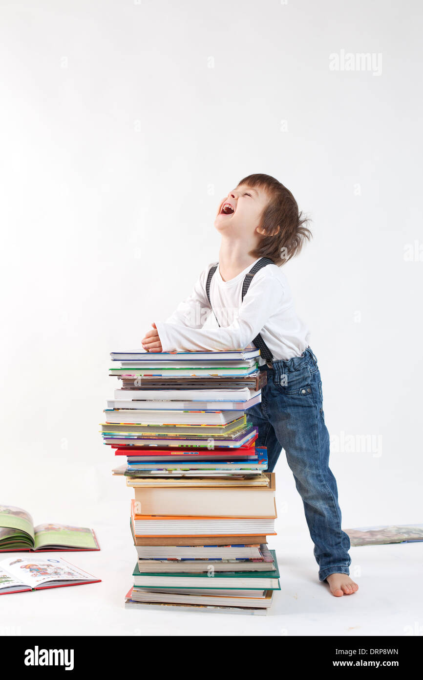 Boy with a pile of books Stock Photo - Alamy