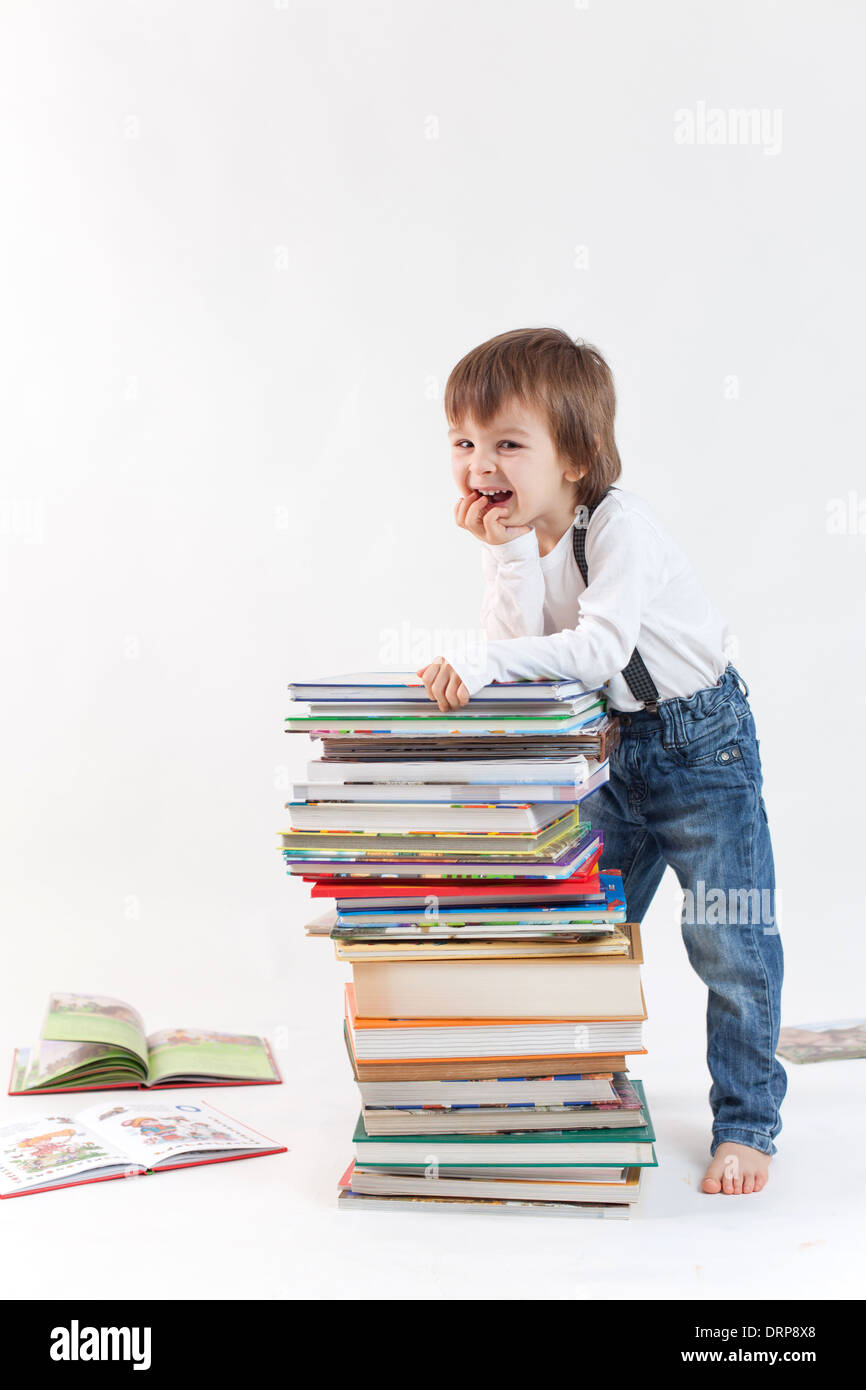 Boy with a pile of books Stock Photo - Alamy