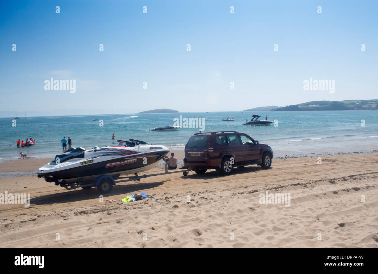 4WD 4x4 4 wheel drive vehicle towing boat onto beach Abersoch Llŷn ...
