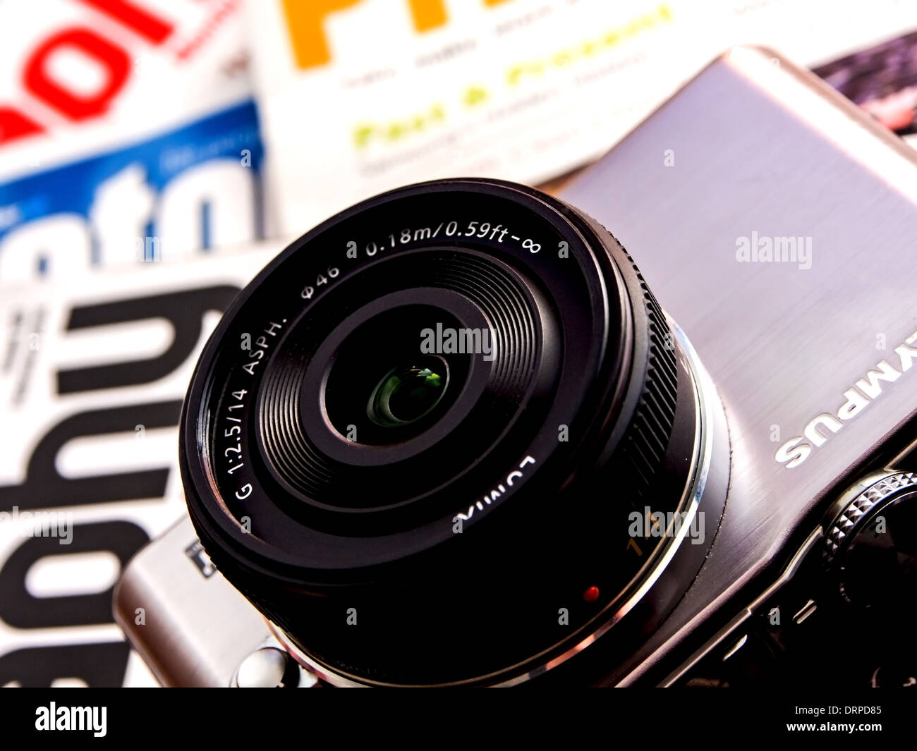 Compact system camera with scattered photography magazines Stock Photo ...