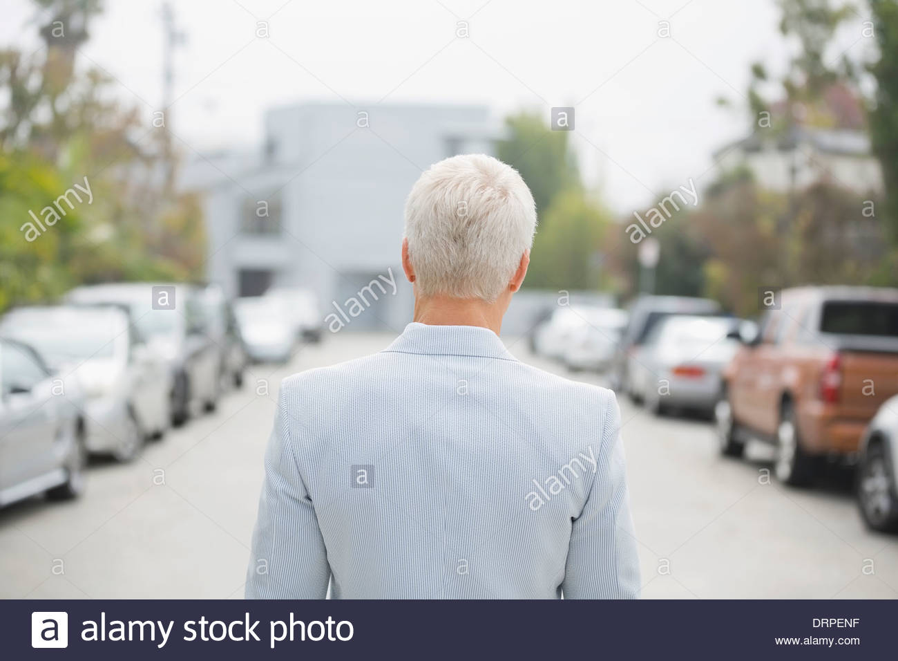 Rear view of man standing on street Stock Photo - Alamy