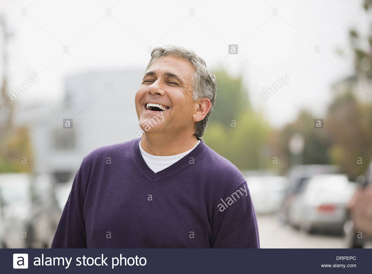 Portrait of man laughing on street Stock Photo - Alamy