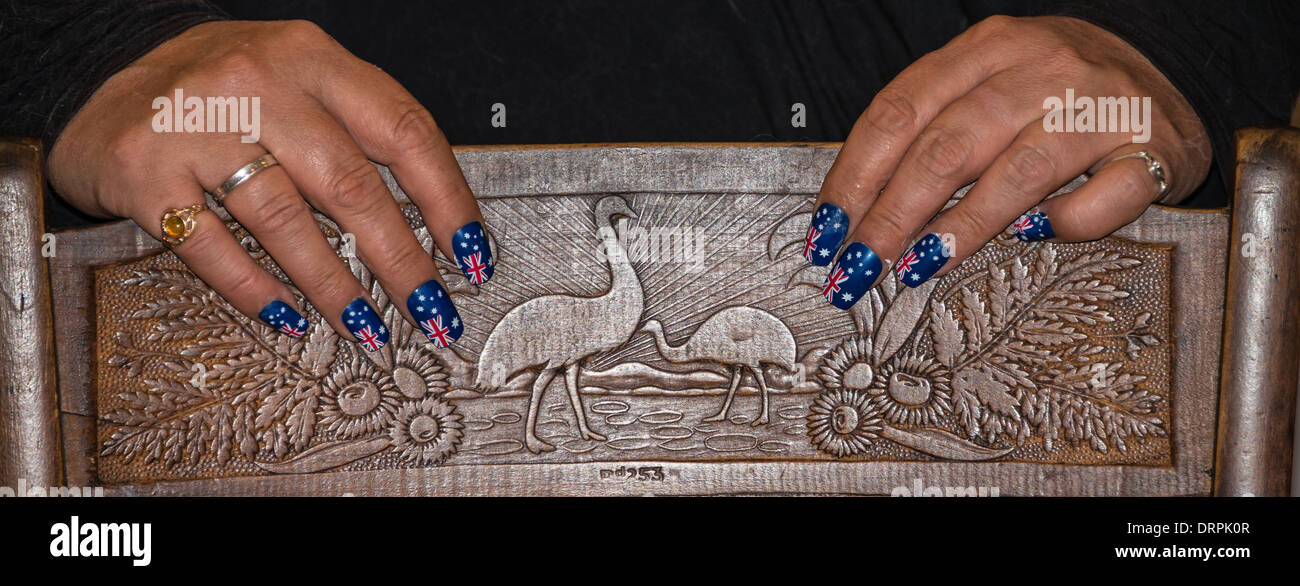 Australian flags painted on nails of hands that are place on an antique ...
