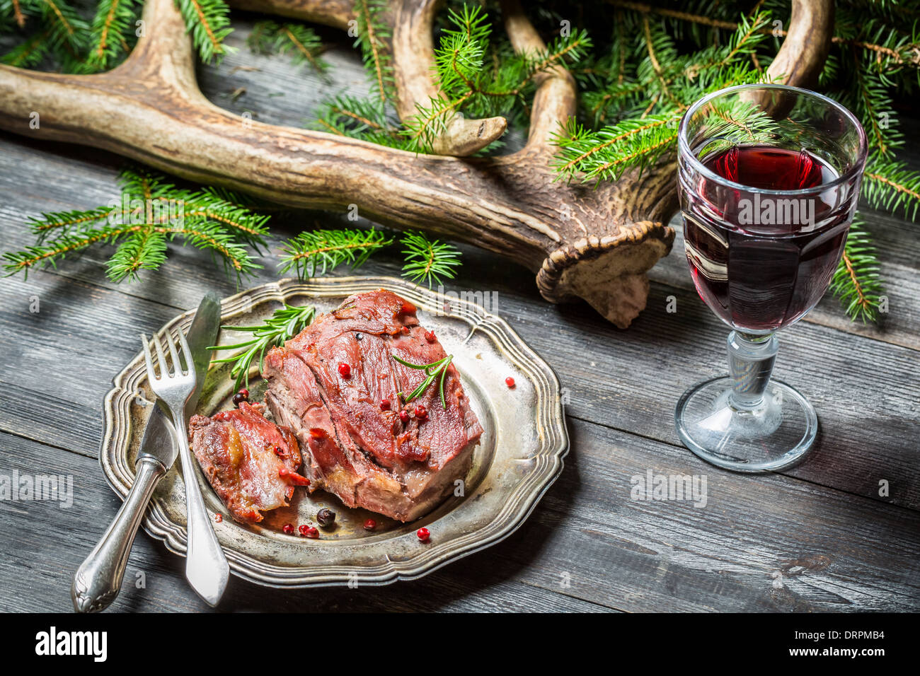 Venison served in the forester lodge with wine Stock Photo - Alamy