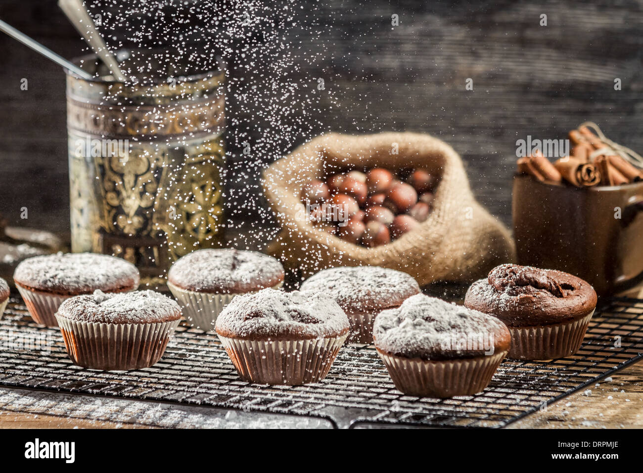 Icing sugar falling on fresh chocolate muffins Stock Photo - Alamy
