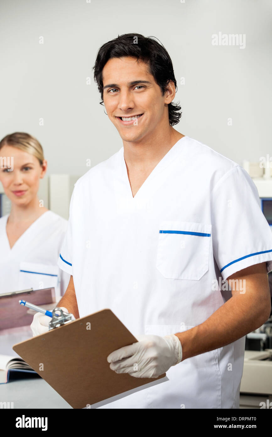 Male Researcher Holding Clipboard In Lab Stock Photo - Alamy