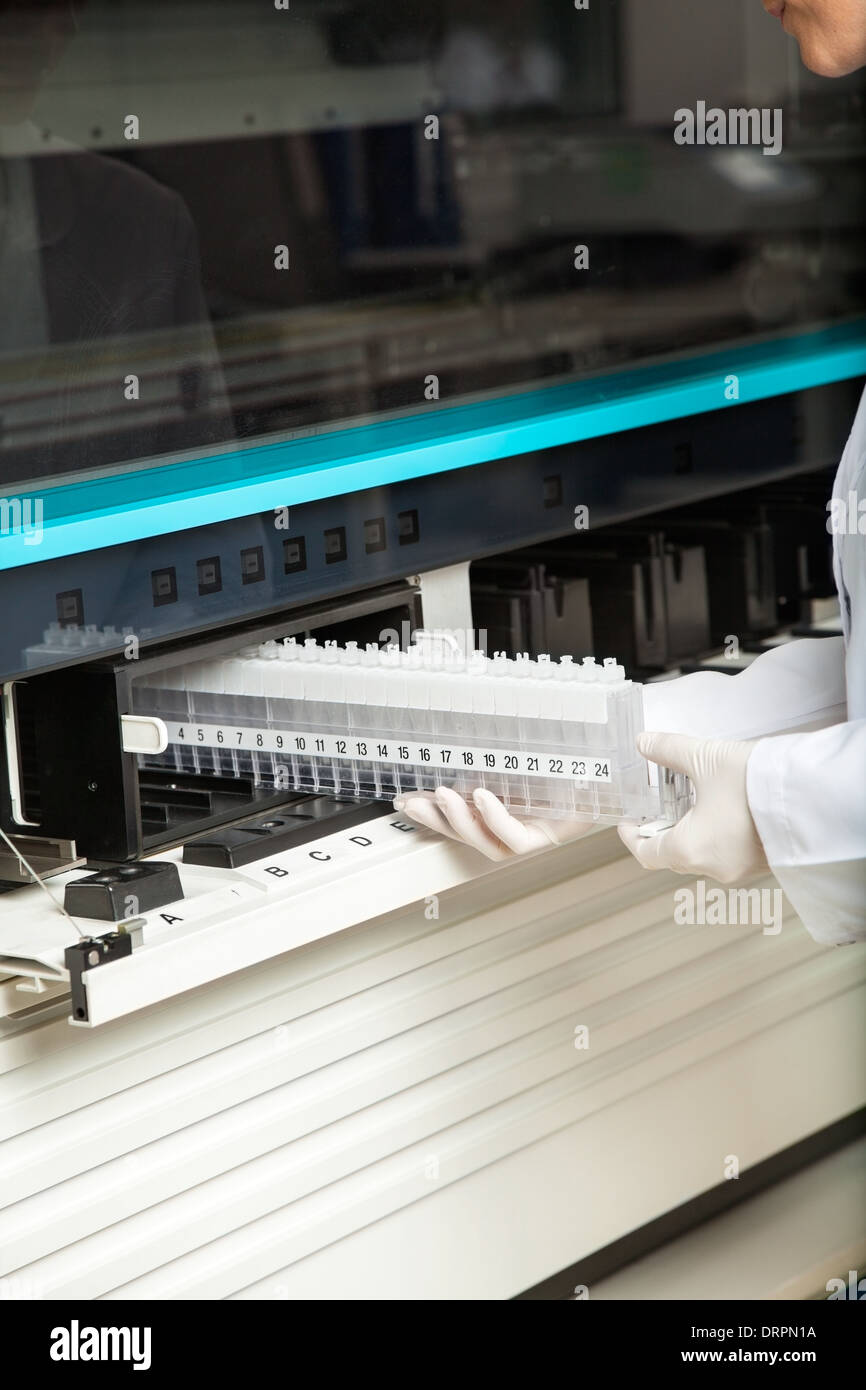 Technician Placing Samples In Analyzer Stock Photo - Alamy