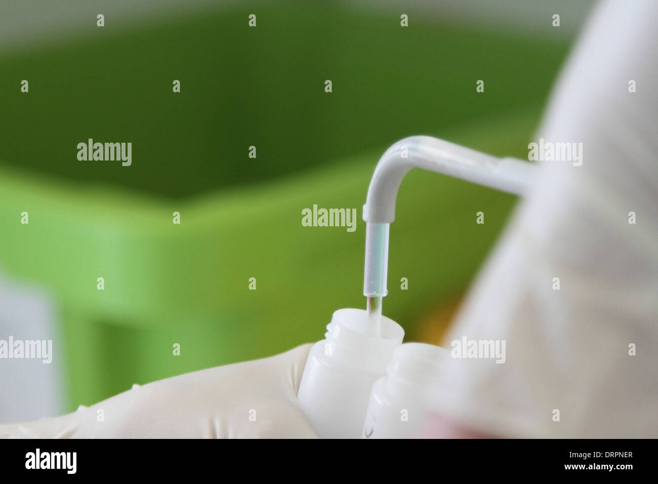 Filling with a filling help bottle liquid in a plastic tube Stock Photo ...