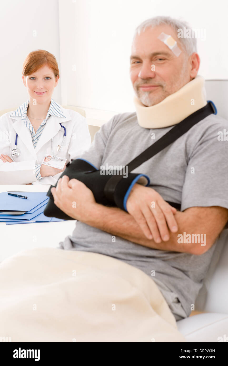 Senior patient broken arm in doctor office Stock Photo - Alamy