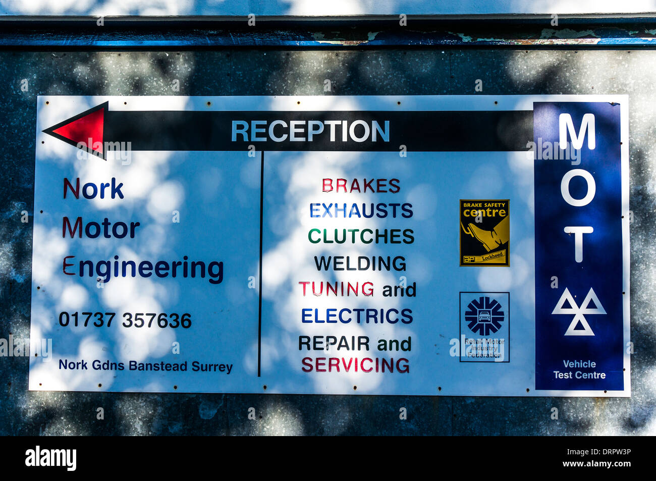 Sign for garage services, including MOT Stock Photo - Alamy
