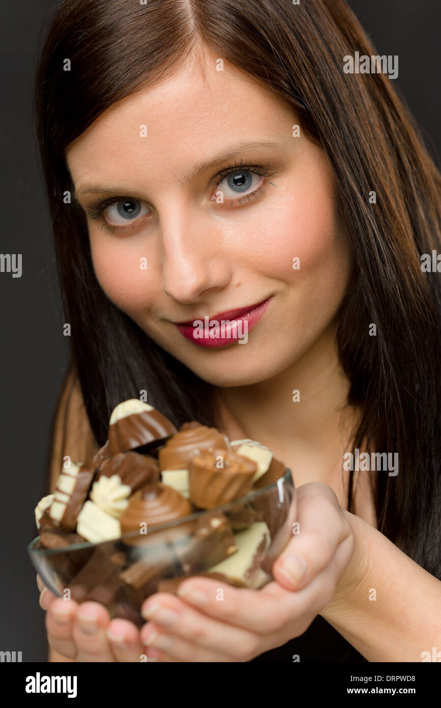 Chocolate - portrait young woman hold candy Stock Photo - Alamy