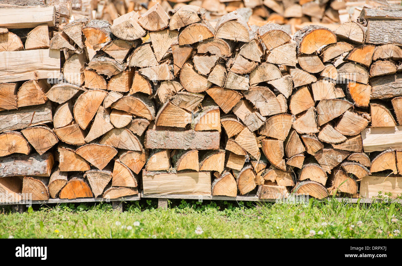 Big stack of firewood logs outdoors Stock Photo - Alamy