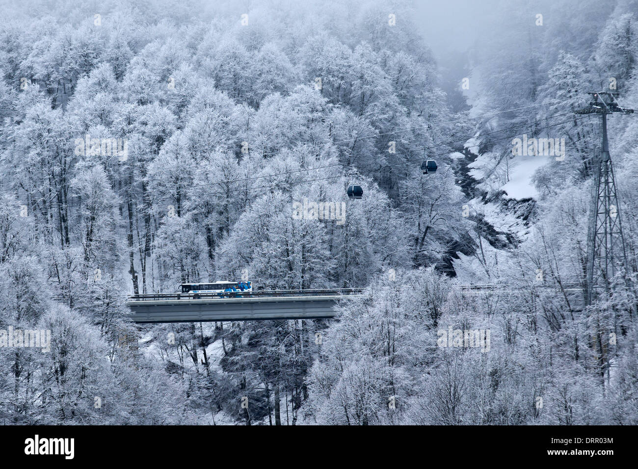 An Olympic shuttle bus is on seen on the road to Rosa Khutor Alpine ...