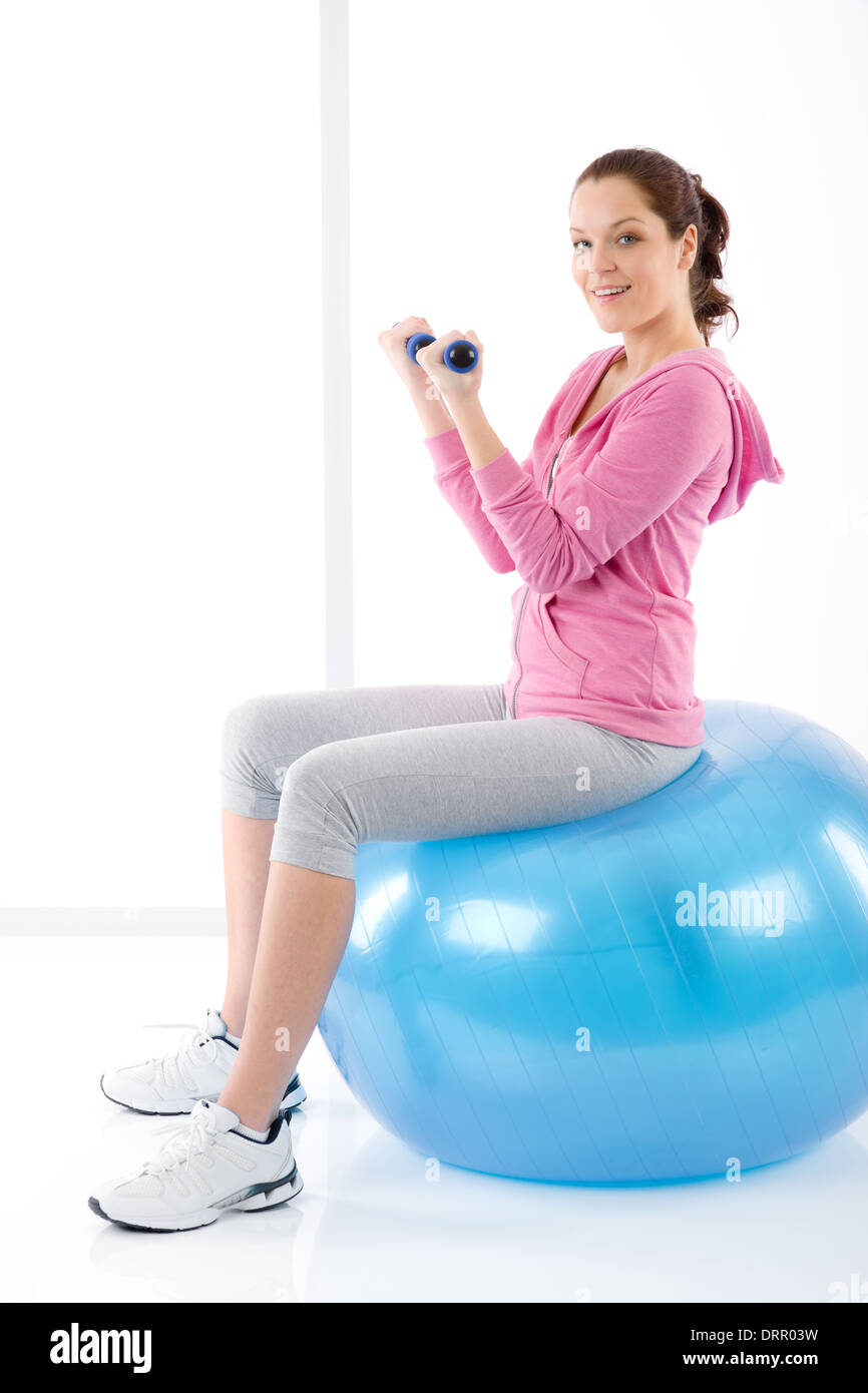 Fitness woman exercise dumbbell ball gym Stock Photo - Alamy