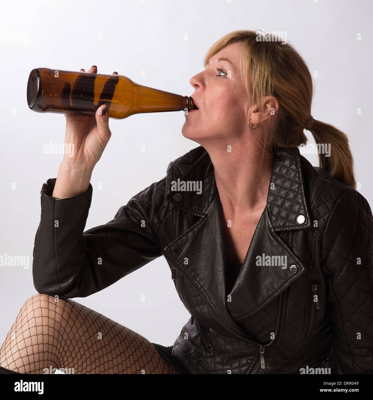 Woman drinking from bottle alcohol hi-res stock photography and images ...