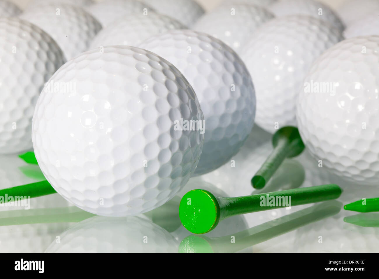 Different golf balls on a glass table Stock Photo - Alamy