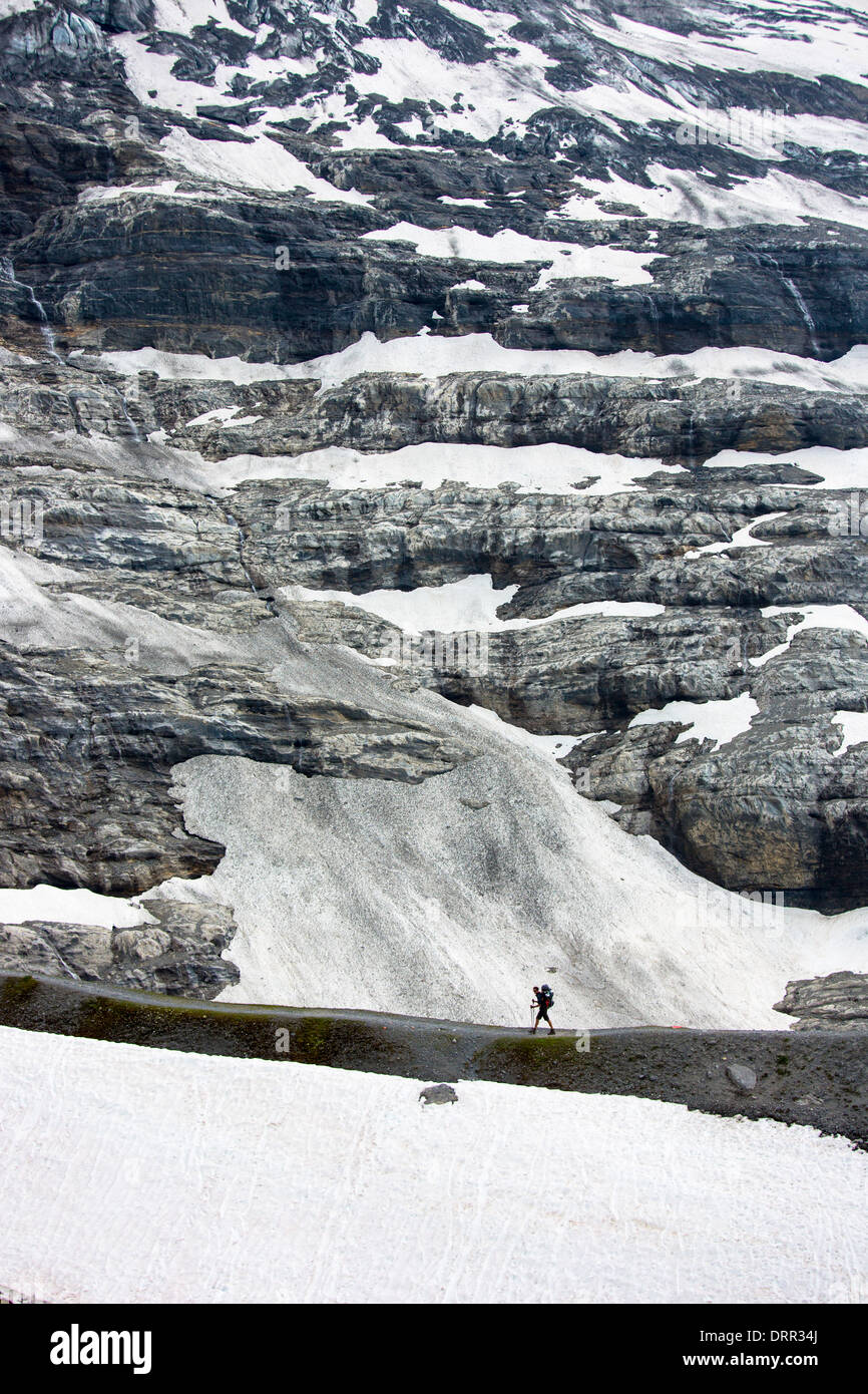 Hiker with camping gear on the Eiger Trail by Eiger Glacier ...
