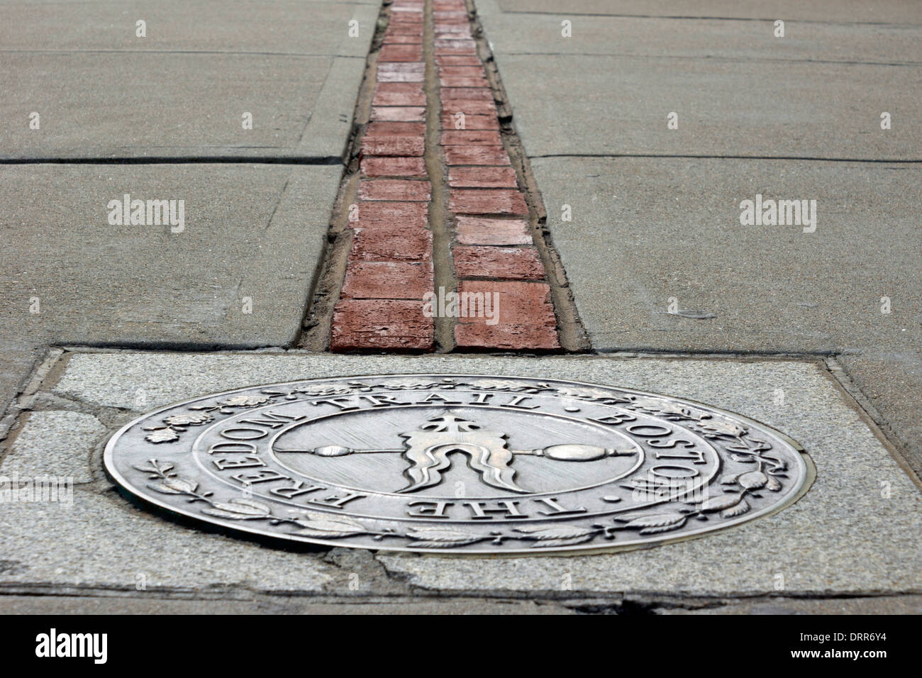 Pavement marker and brick line indicating the Freedom Trail in Boston ...