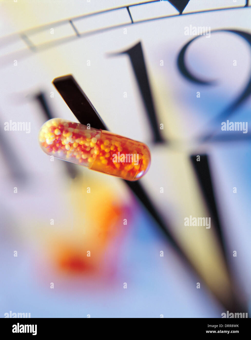 Time Release Capsule on Minute Hand of Clock Stock Photo - Alamy