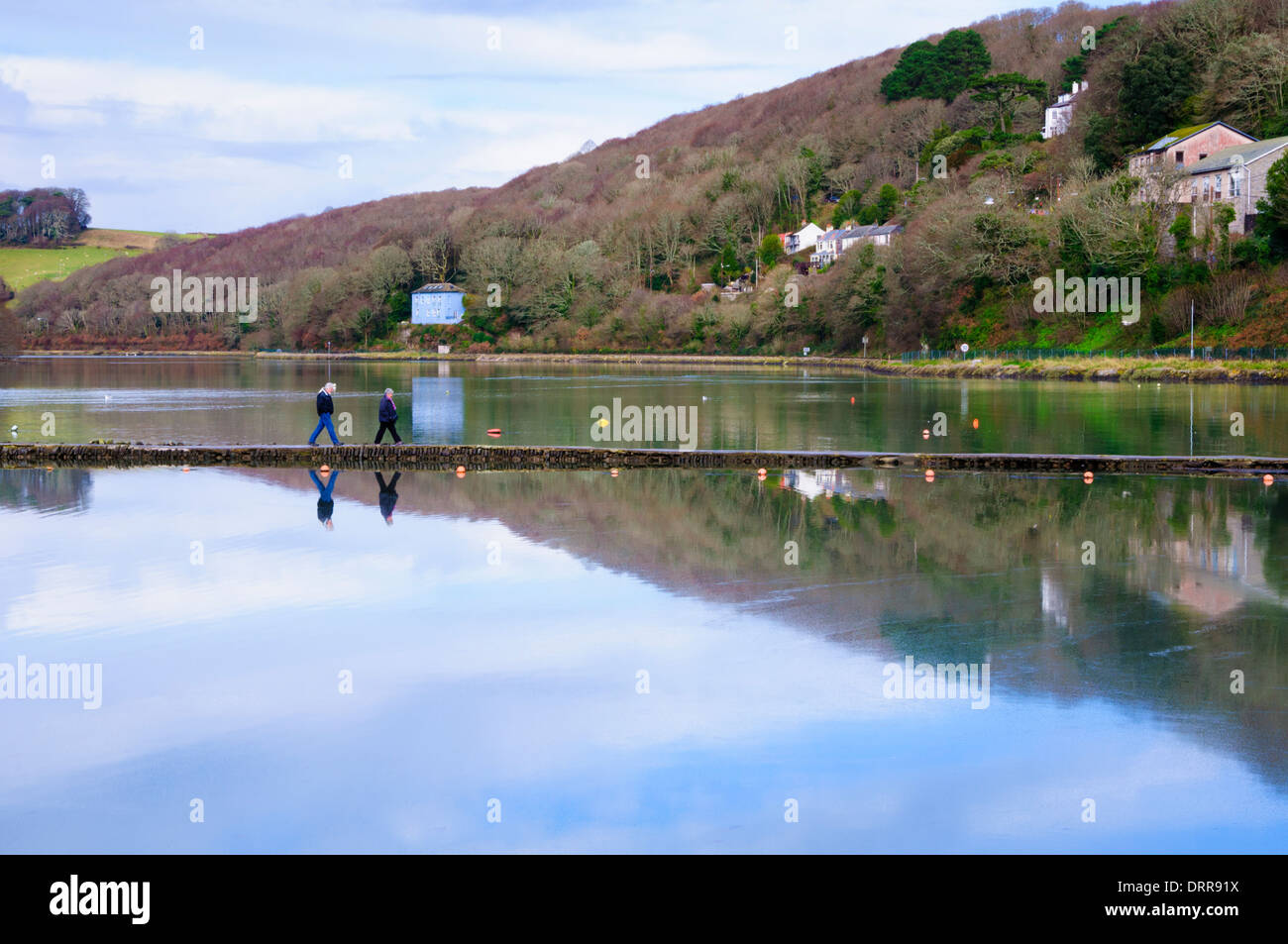 Scenic view of a couple walking around the Mill Pool in Looe, Cornwall ...