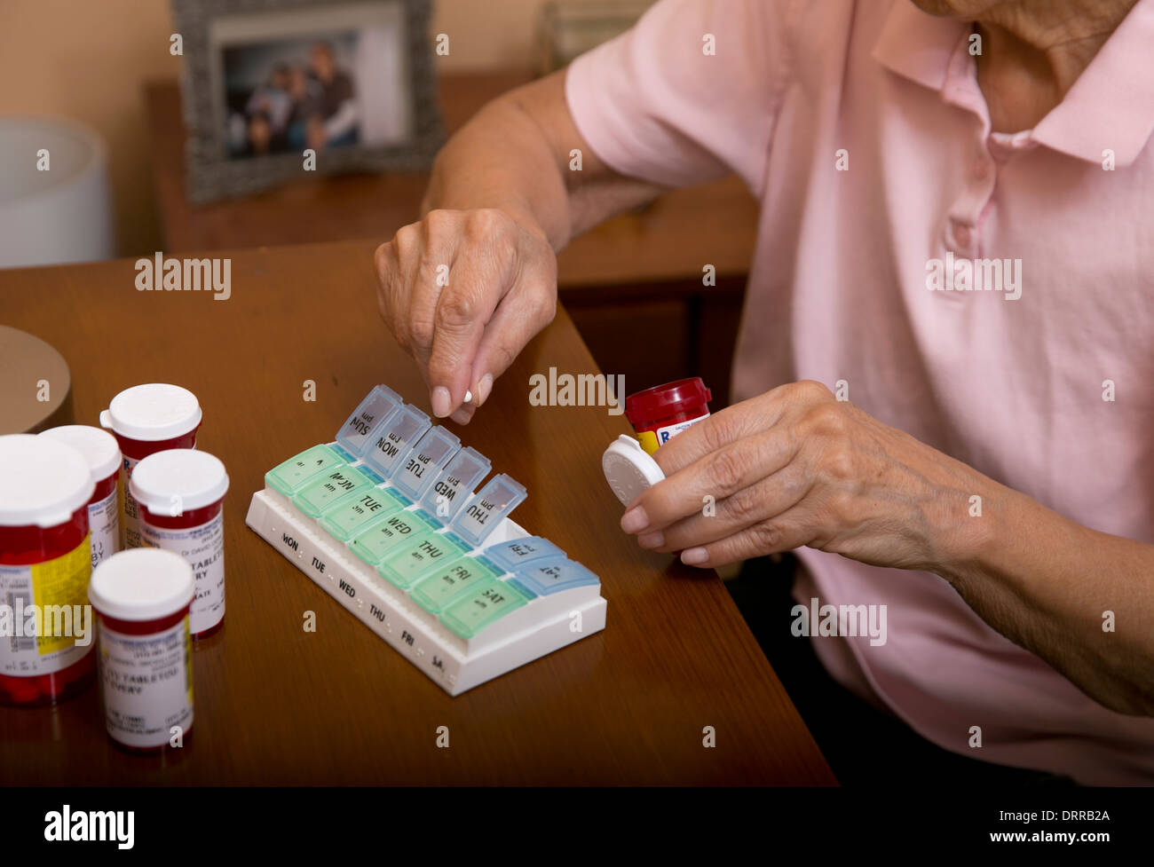 75 year old Hispanic senior citizen woman organizes her multiple ...