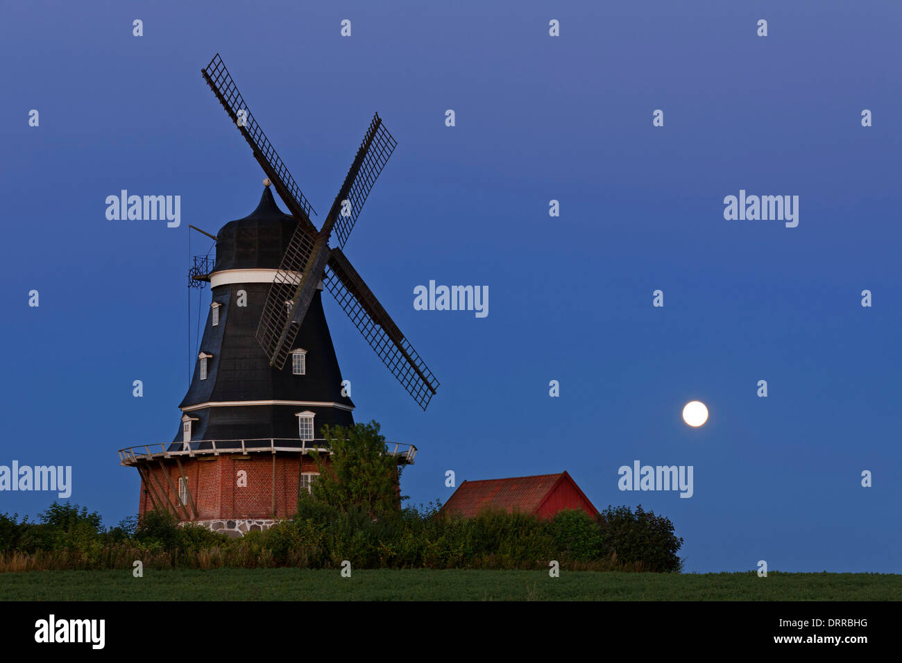Traditional windmill in field at full moon, Krageholm, Skåne / Scania ...