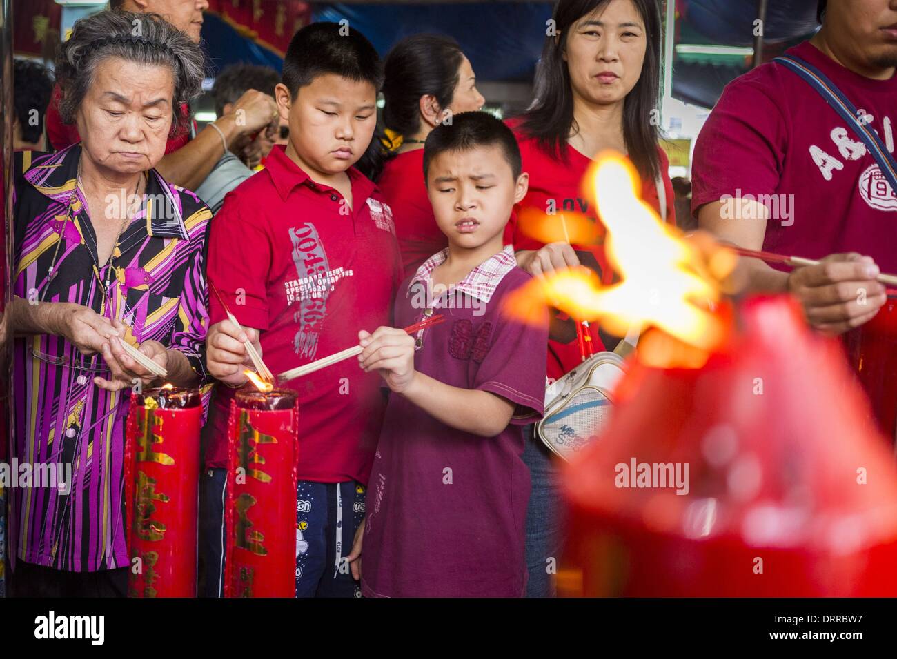Bangkok, Thailand. 31st Jan, 2014. People make offerings at the Poh ...