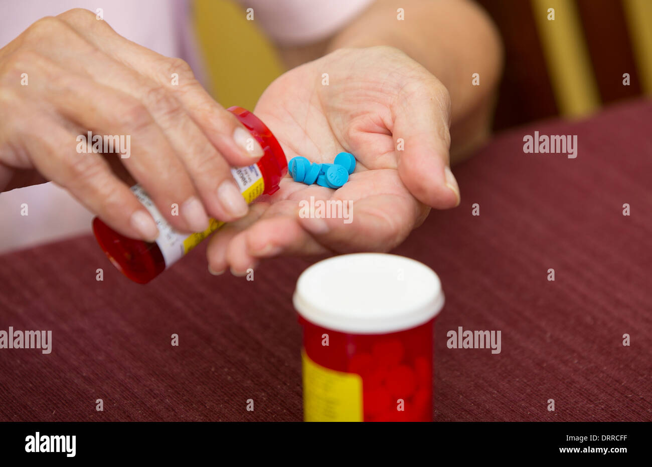 Female 74 year old senior citizen organizes her prescription drug ...