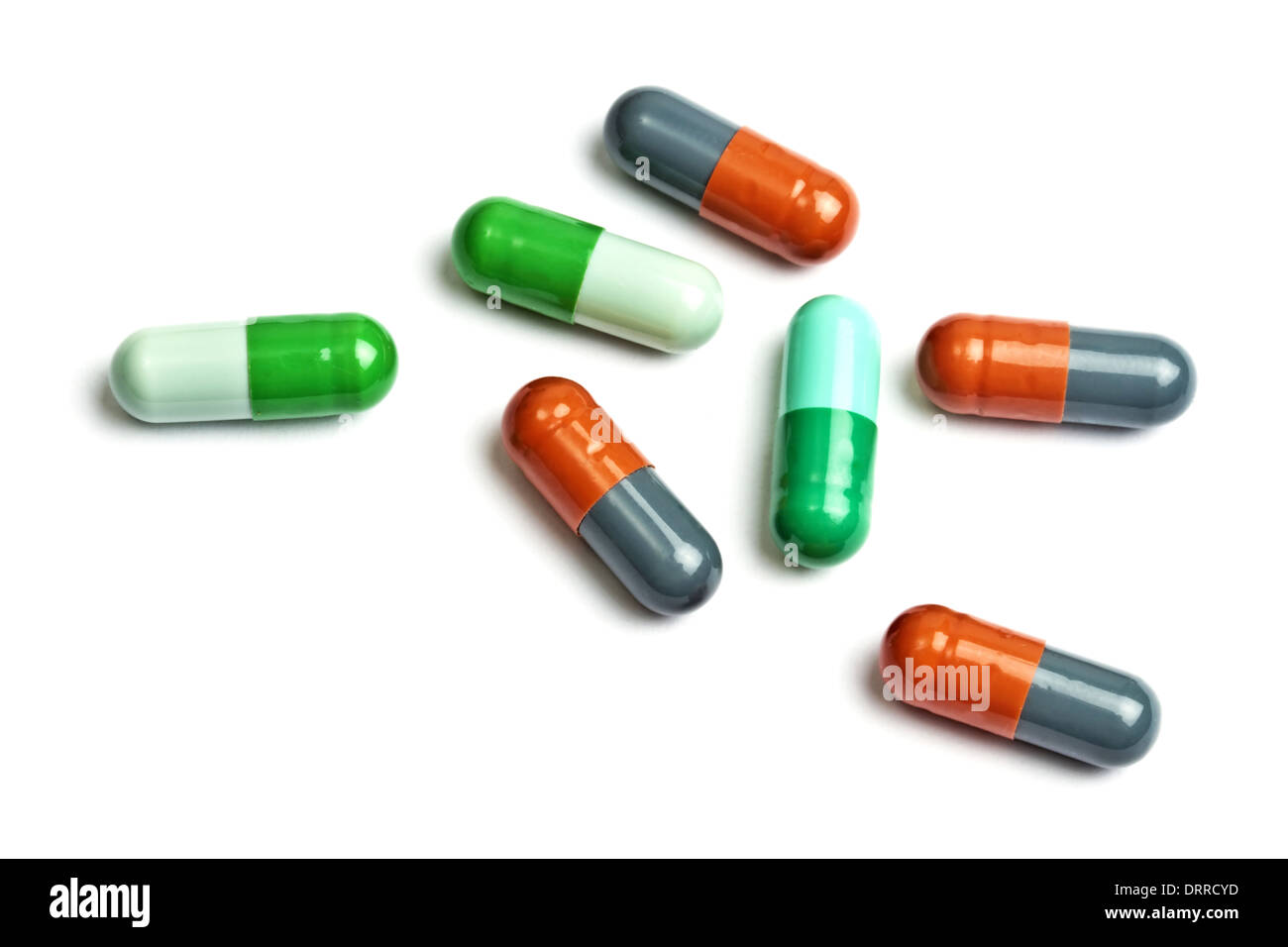 A few colorful capsules isolated on white Stock Photo - Alamy