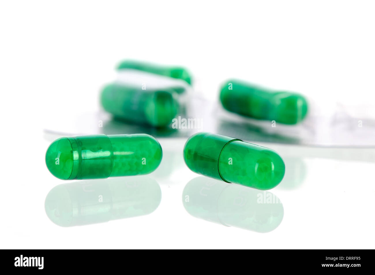 Green medicine in capsules isolated over white background Stock Photo ...