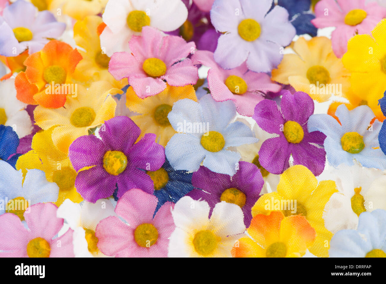 Background with colorful artificial flowers Stock Photo - Alamy