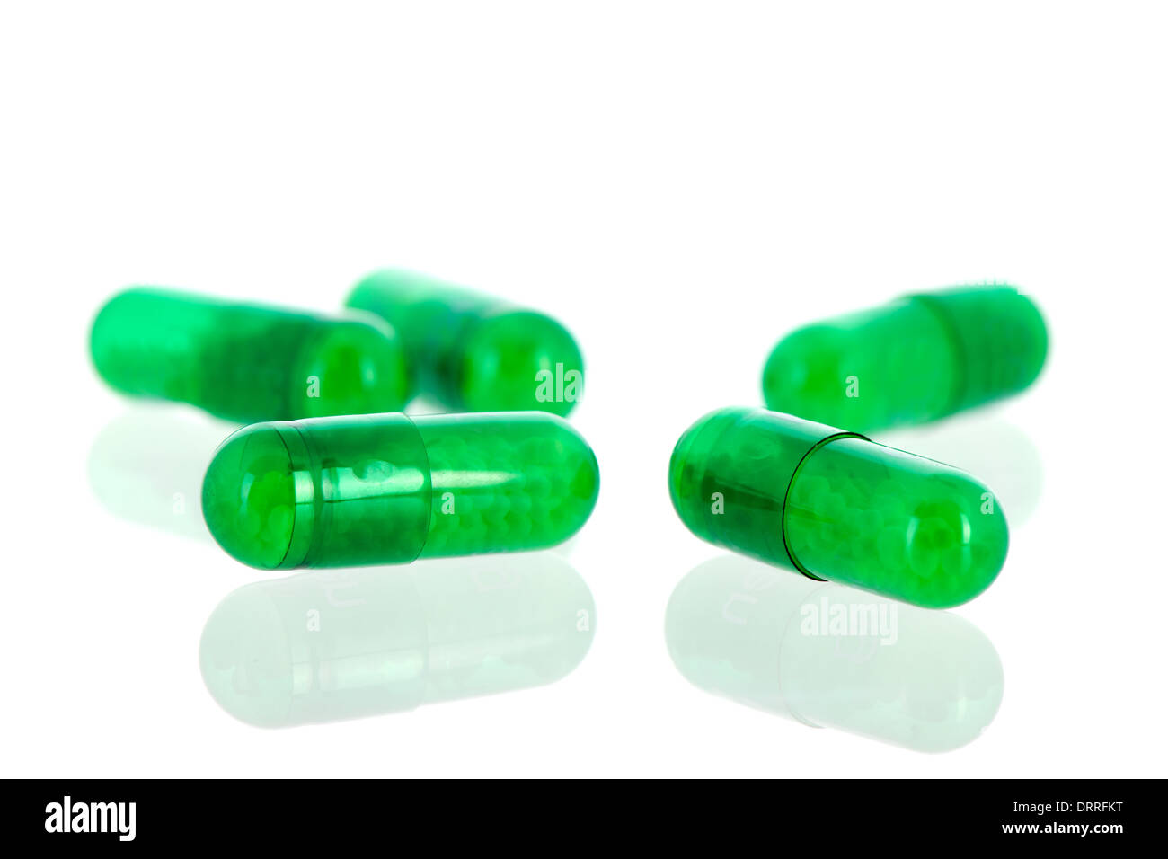 Green medicine in capsules isolated over white background Stock Photo ...