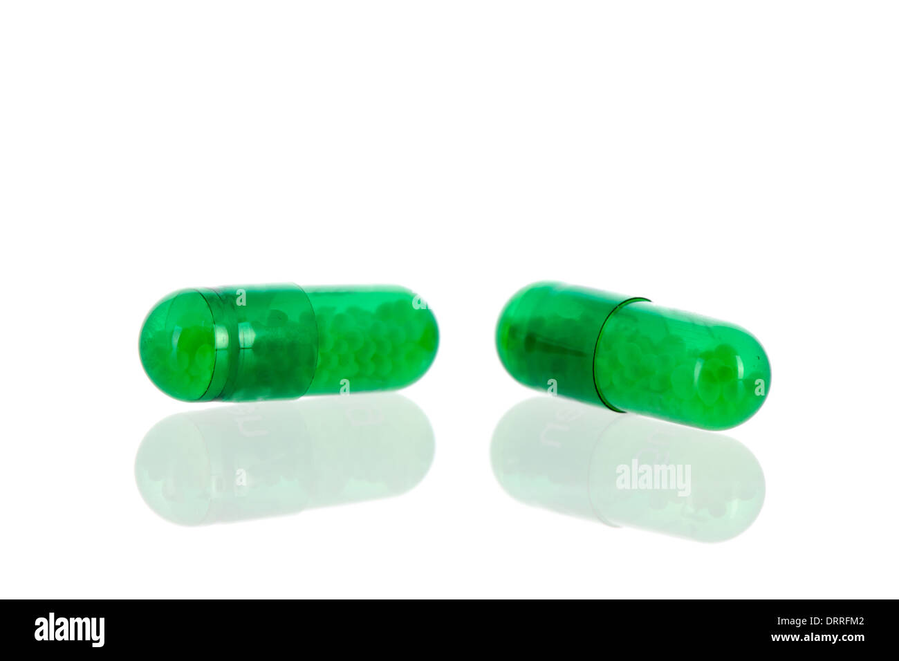 Green medicine in capsules isolated over white background Stock Photo ...