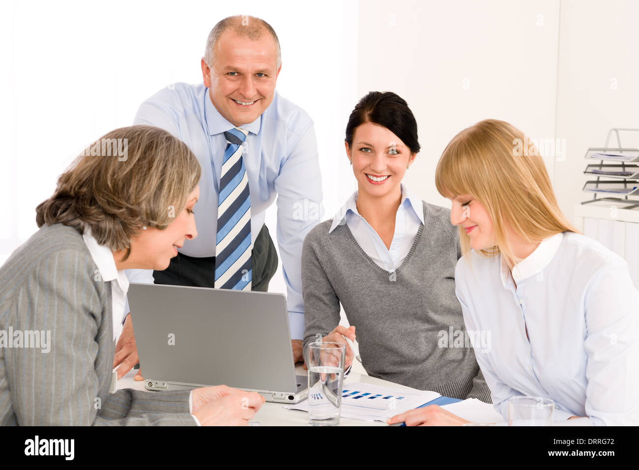 Business team meeting people around table Stock Photo - Alamy