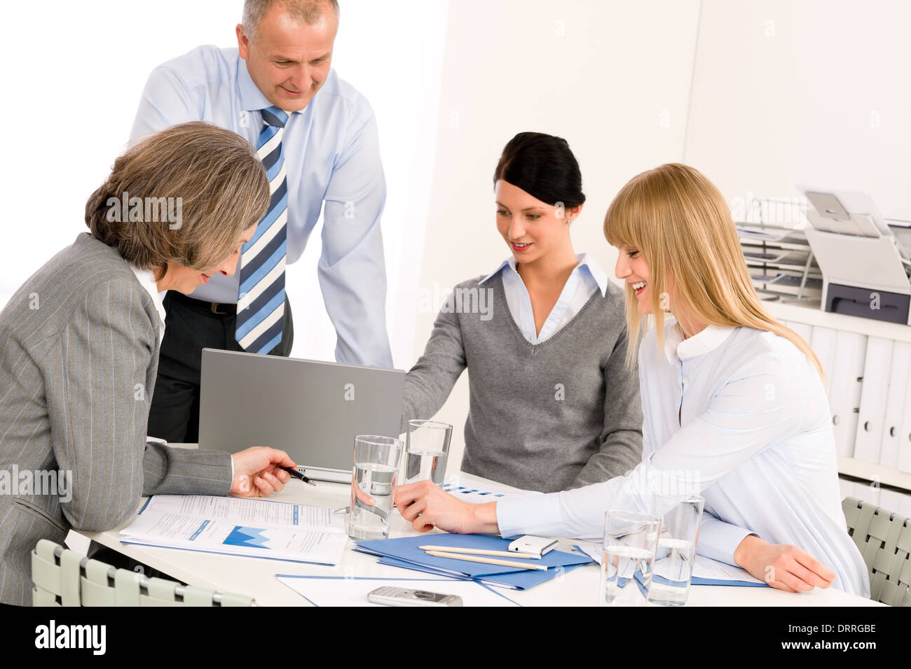Business team meeting people around table Stock Photo - Alamy