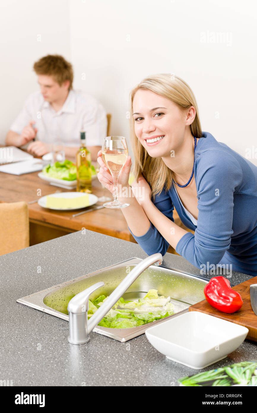 Happy woman kitchen cook enjoy white wine Stock Photo - Alamy