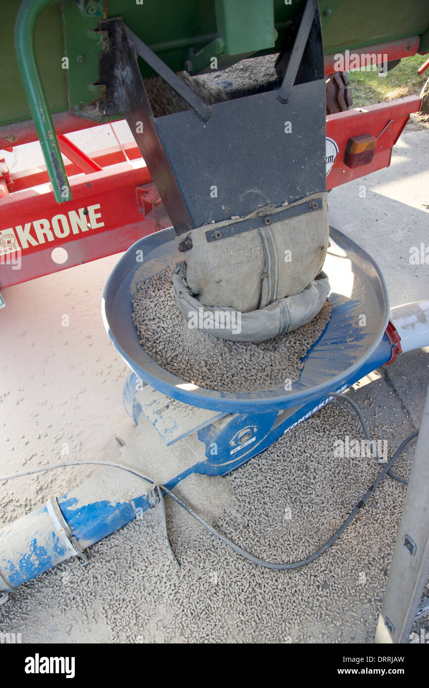 Grain blower blowing wood pellets into a house Stock Photo - Alamy