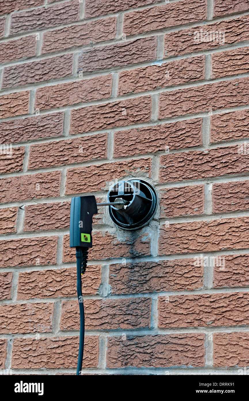 Gas sniffer instrument testing the output of a boiler flue as part of a ...
