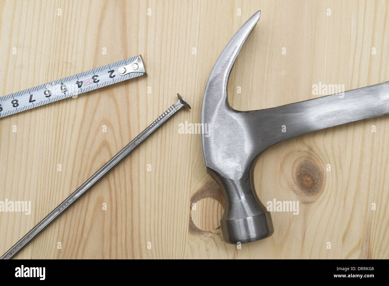 Old hammer , tape measure and nail Stock Photo - Alamy
