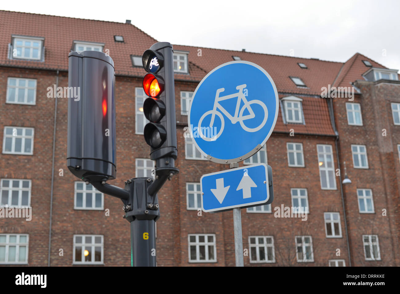 Bicycle sign in Copenhagen with red street light Stock Photo - Alamy