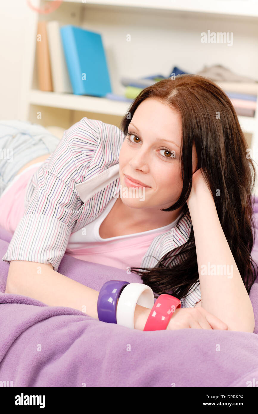 Young happy student relax lying on bed Stock Photo - Alamy