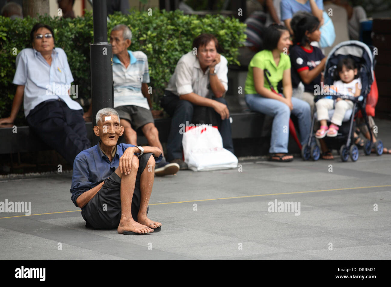 People sitting around a plaza in Chinatown, Singapore, Asia Stock Photo ...
