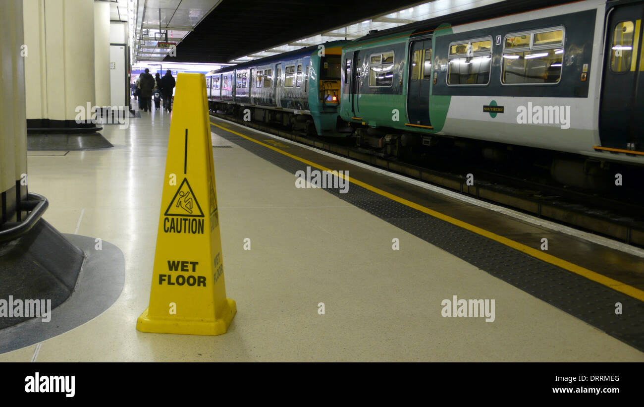 Health and safety notice re a wet platform floor at a London railway ...
