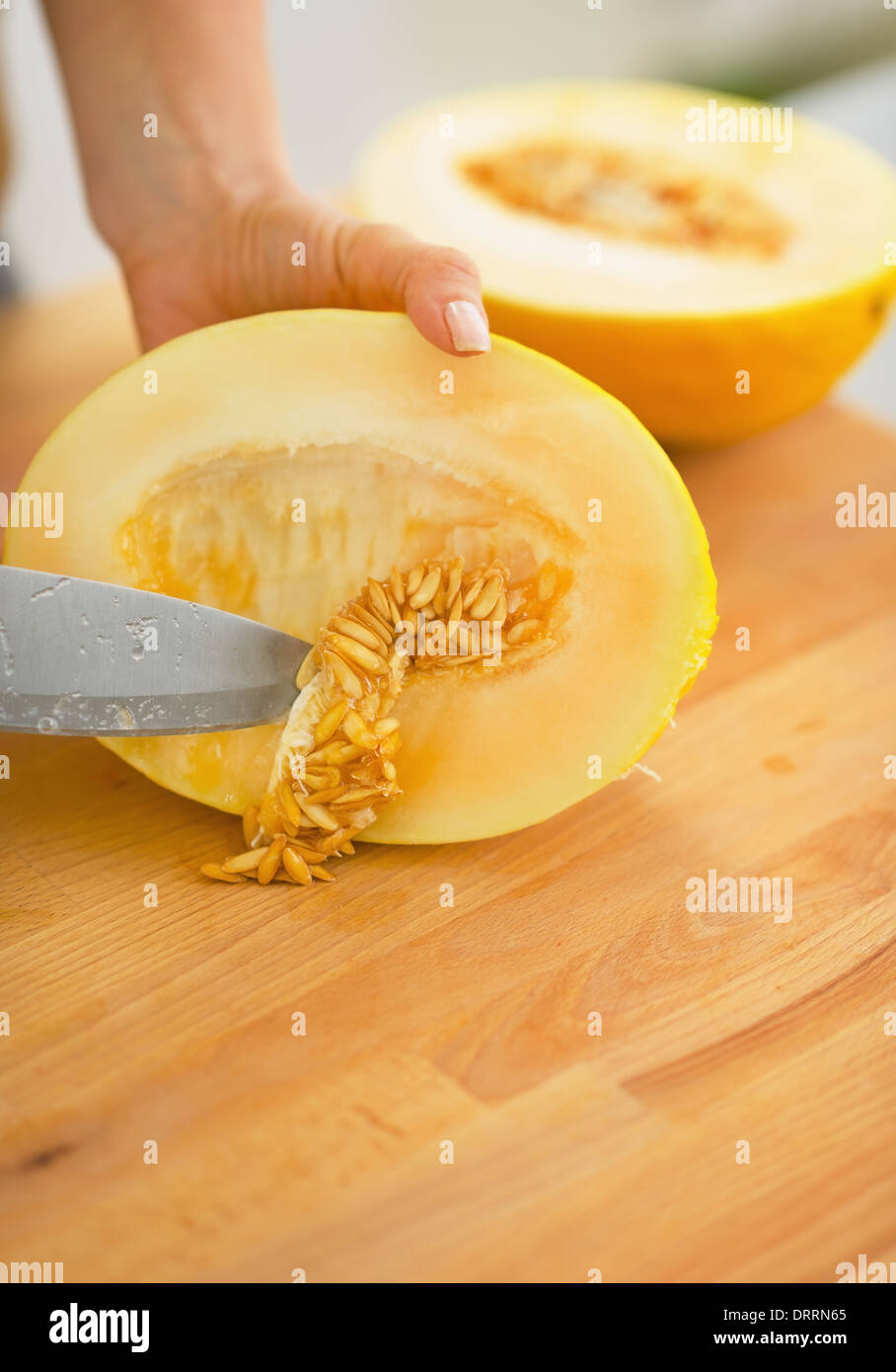 Closeup on woman cutting melon Stock Photo - Alamy