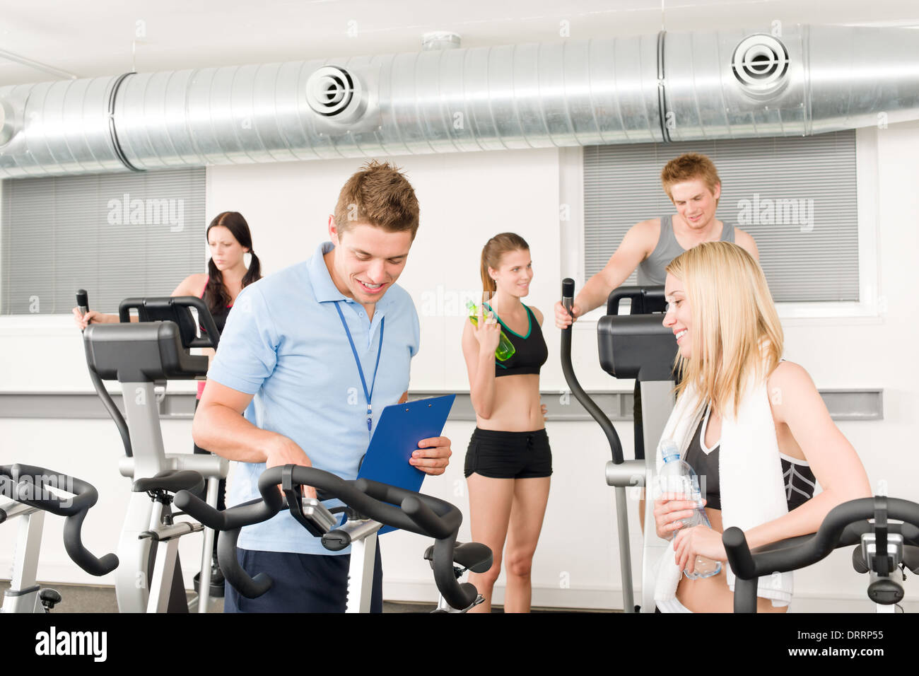 Young fitness instructor gym people spinning Stock Photo - Alamy