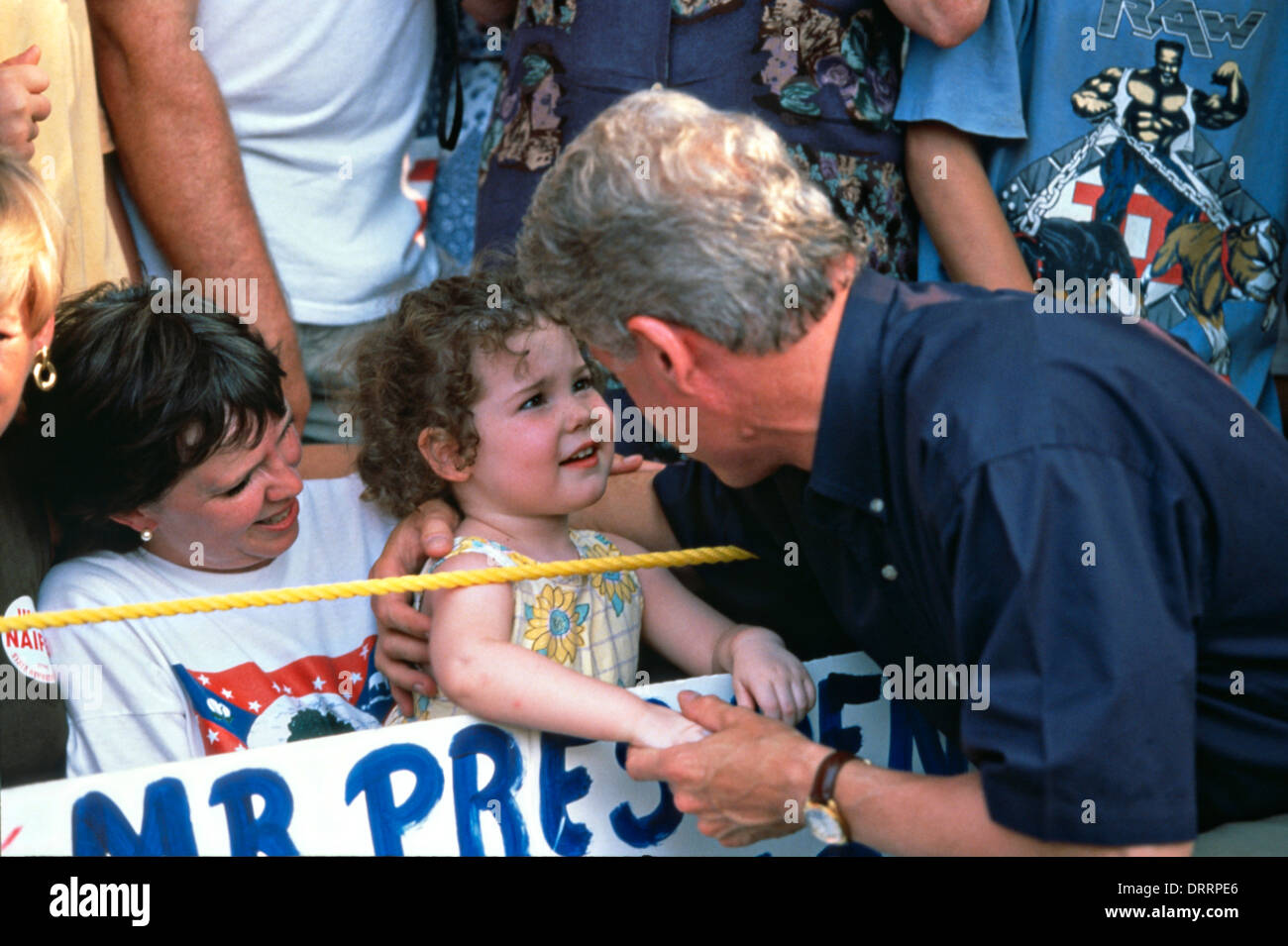 US President Bill Clinton speaks to a small girl during a campaign stop ...
