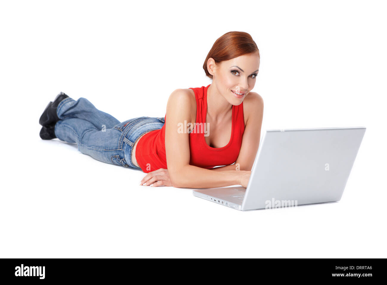 Cute female lying down and using a laptop Stock Photo - Alamy