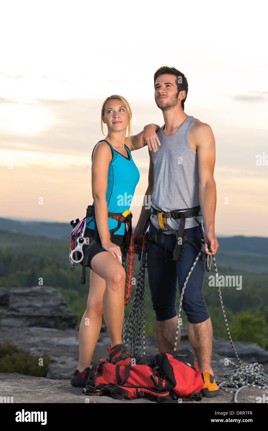 Rock climbing active couple on top sunset Stock Photo - Alamy