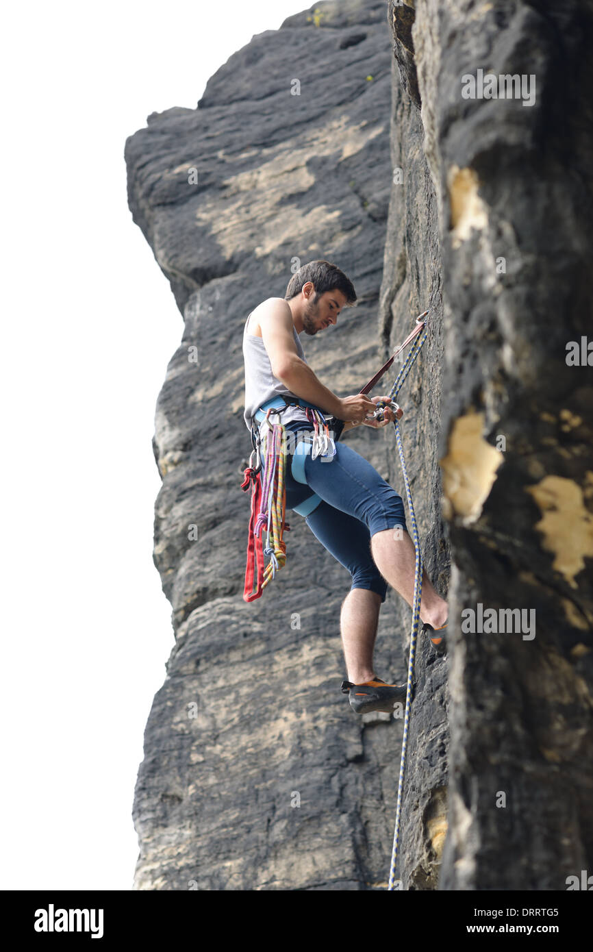 Rock climbing fit man on rope sunny Stock Photo - Alamy